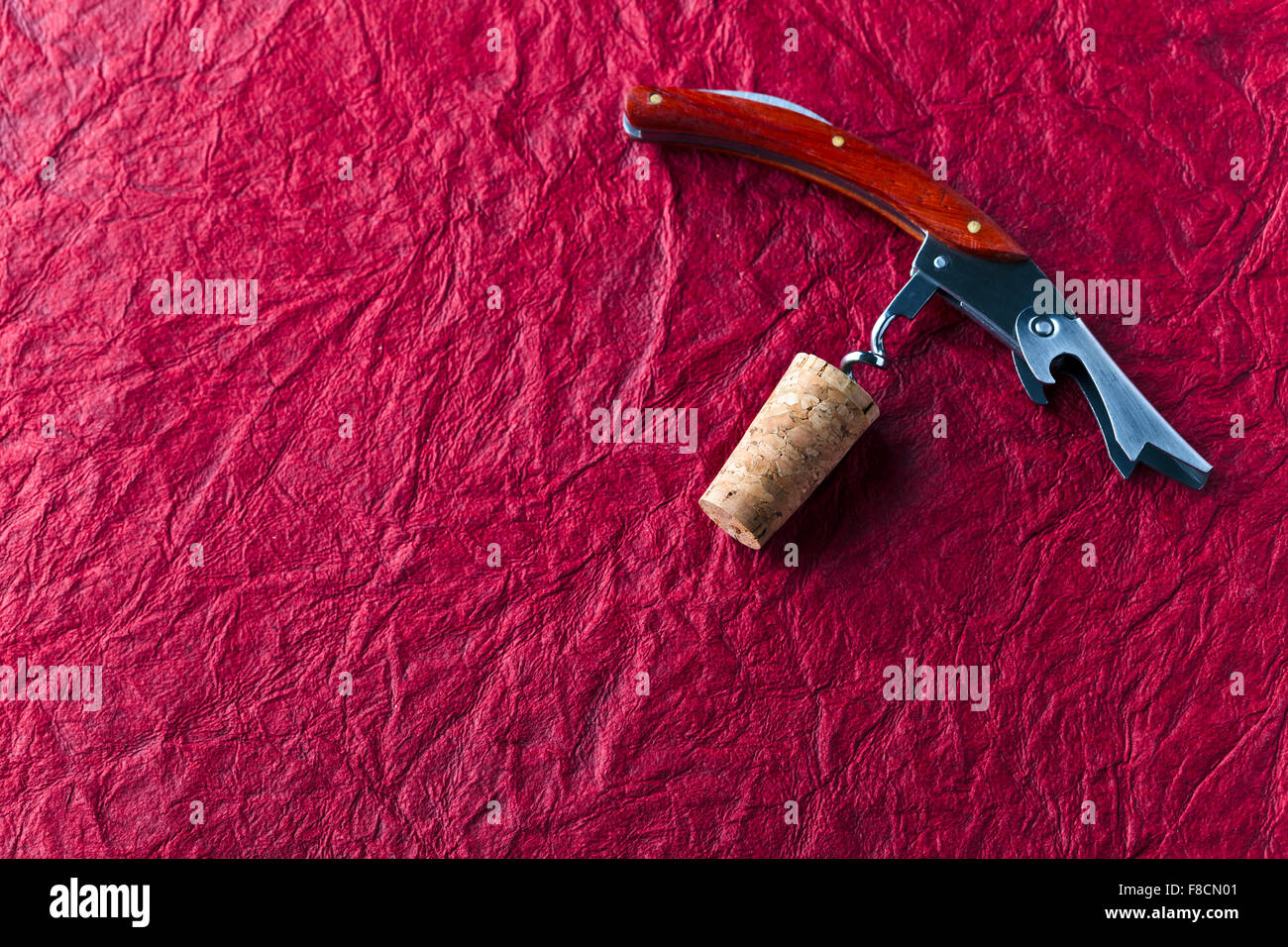 corkscrew and cork on a red background Stock Photo - Alamy