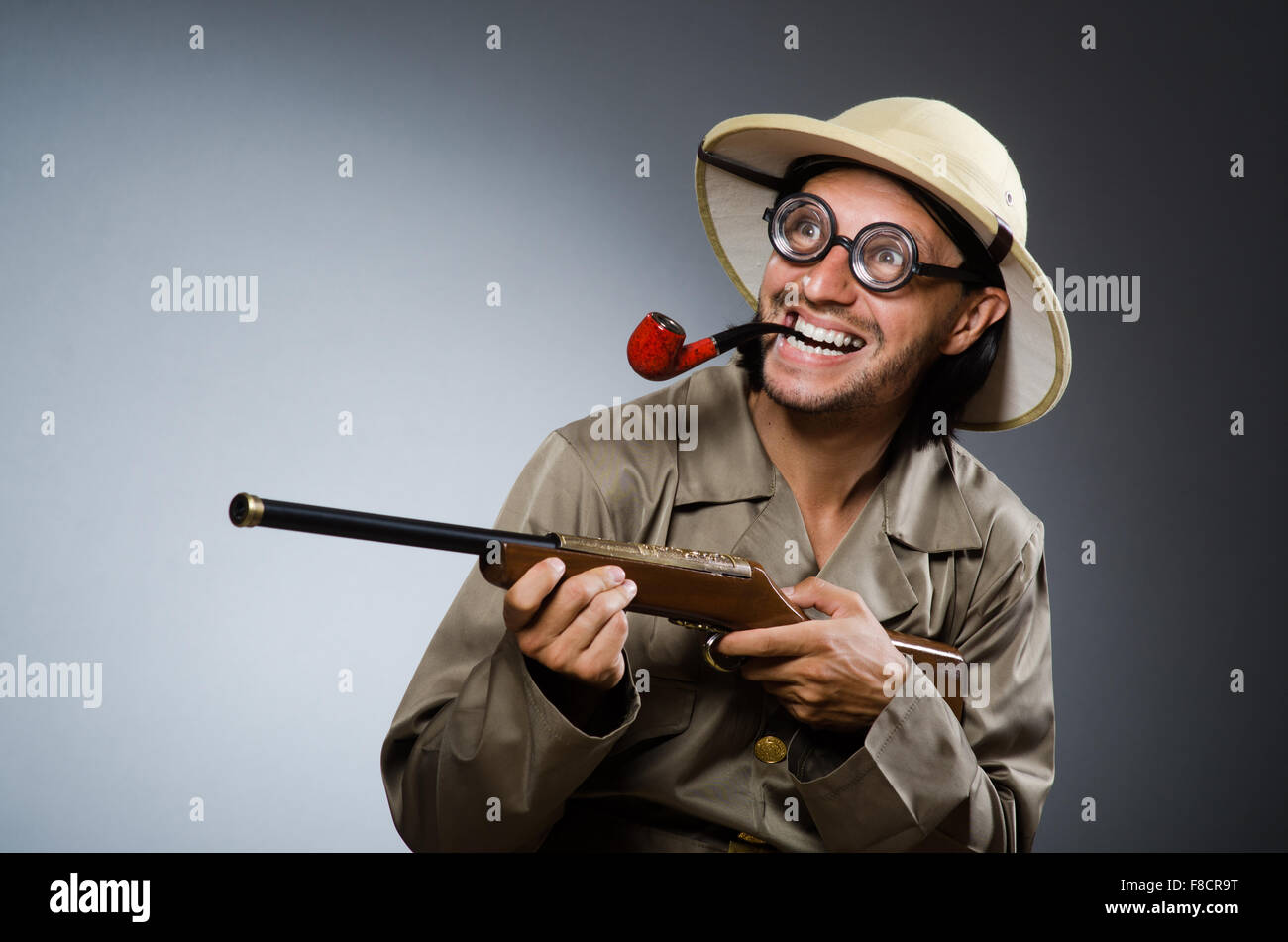 Hunter with rifle and smoking pipe Stock Photo - Alamy