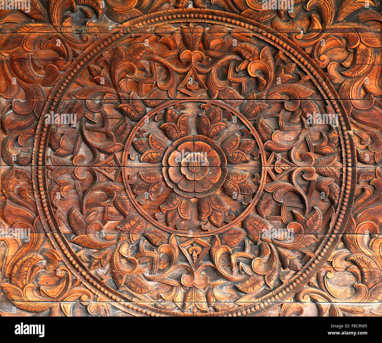 Beautiful floral pattern on the wooden wall is photographed close up ...