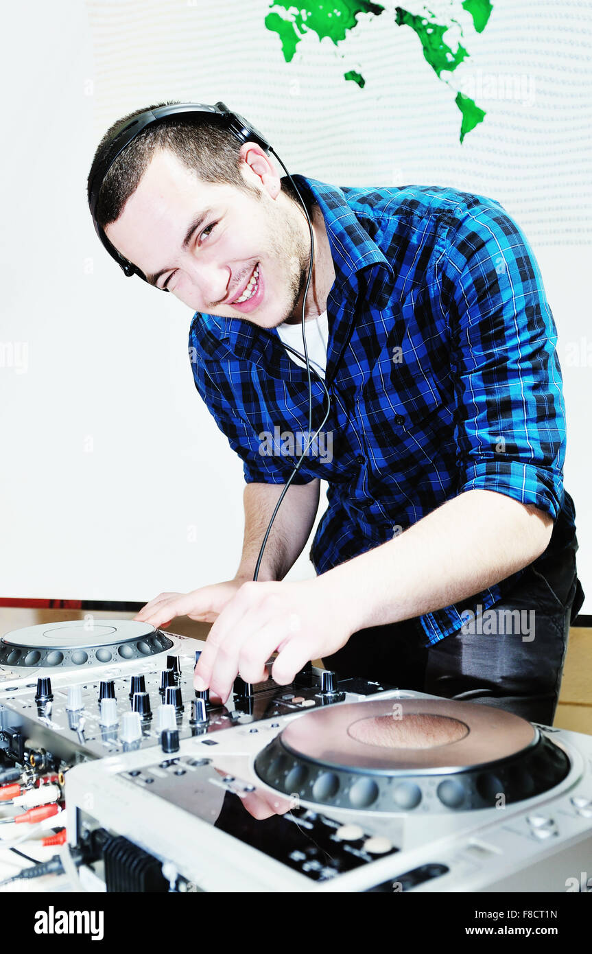 young dj man with headphones and compact disc dj equipment on party ...