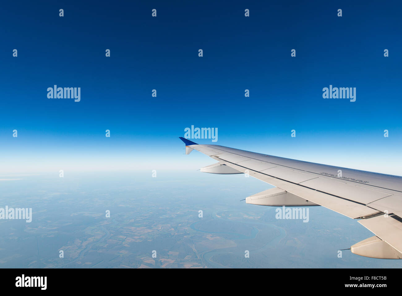 Airplane wing out of window Stock Photo - Alamy