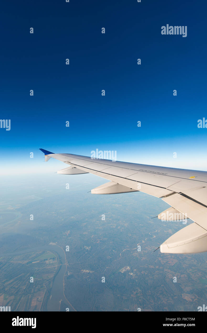 Airplane wing out of window Stock Photo - Alamy