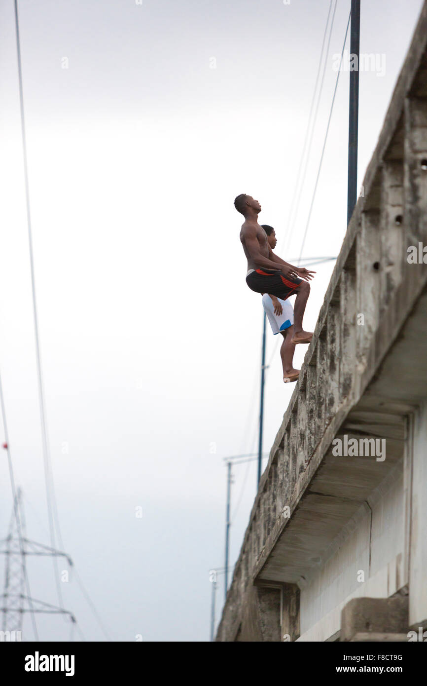 Teenagers jumping back side from a bridge, Ecuador Stock Photo - Alamy