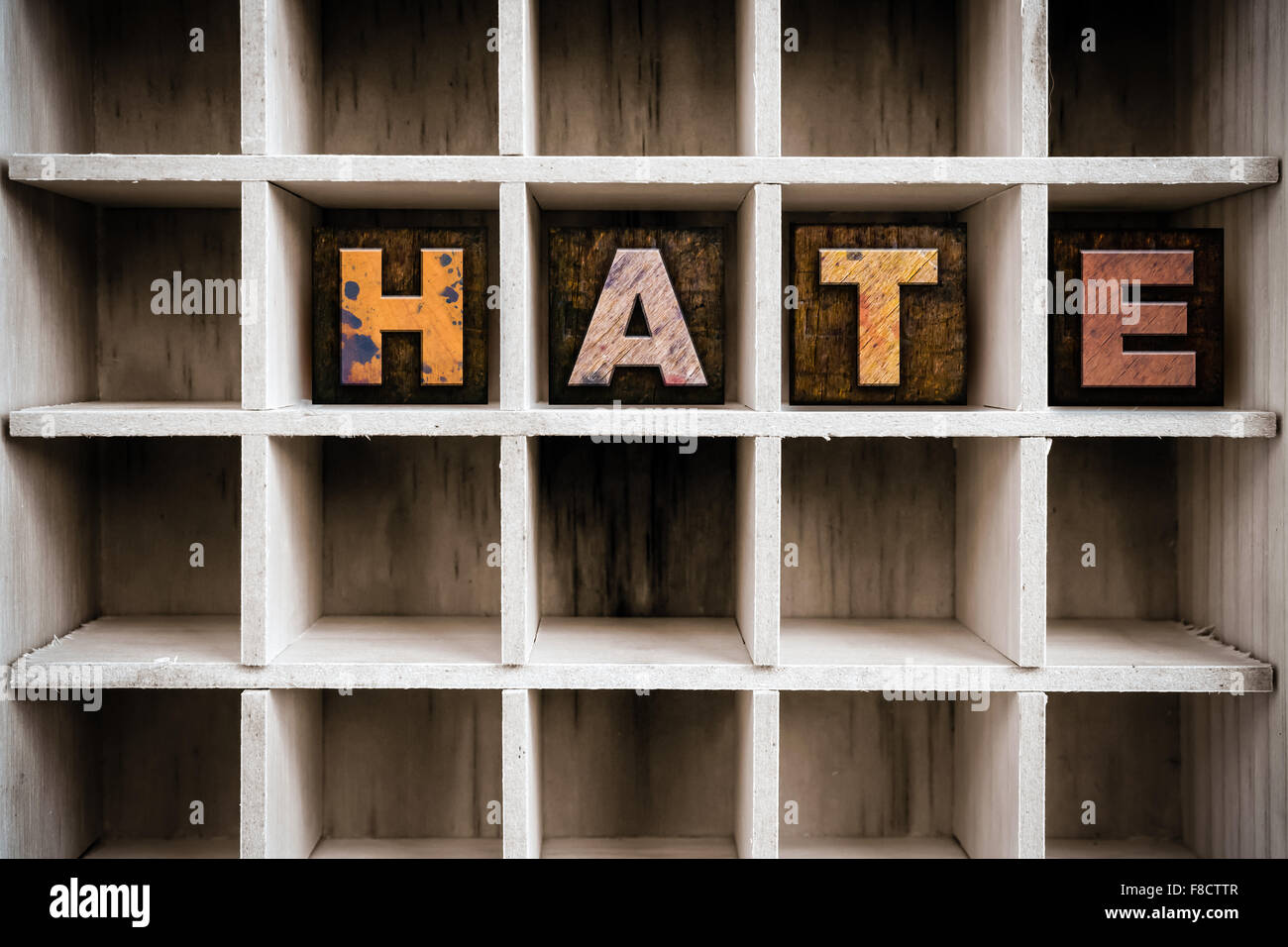 The word "HATE" written in vintage ink stained wooden letterpress type ...