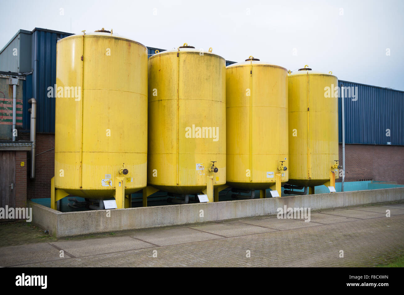 four industrial silos on a row Stock Photo - Alamy