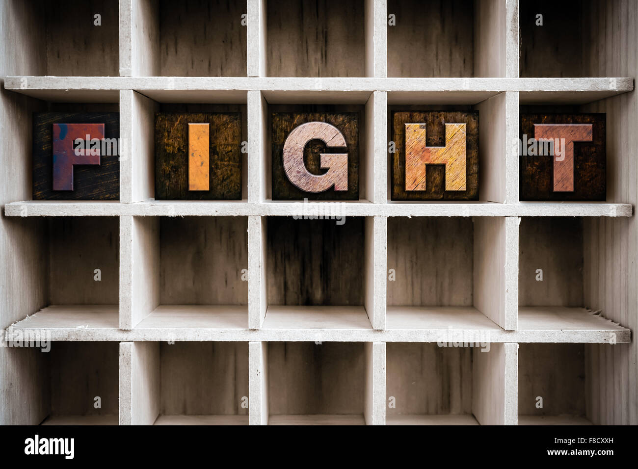 The word "FIGHT" written in vintage ink stained wooden letterpress type ...