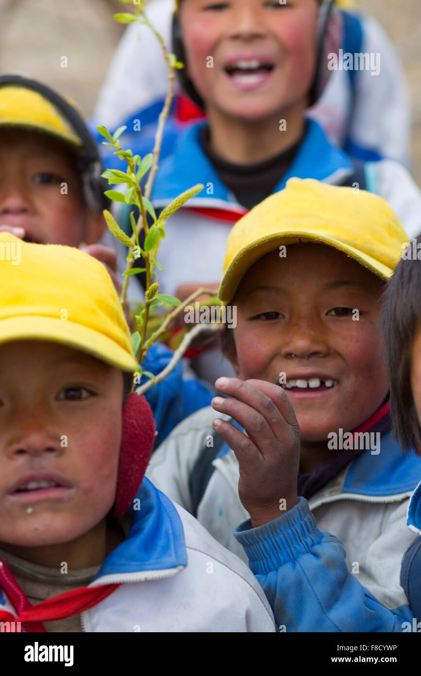 Tibetan kids playing with a red flag in Tibet Stock Photo - Alamy