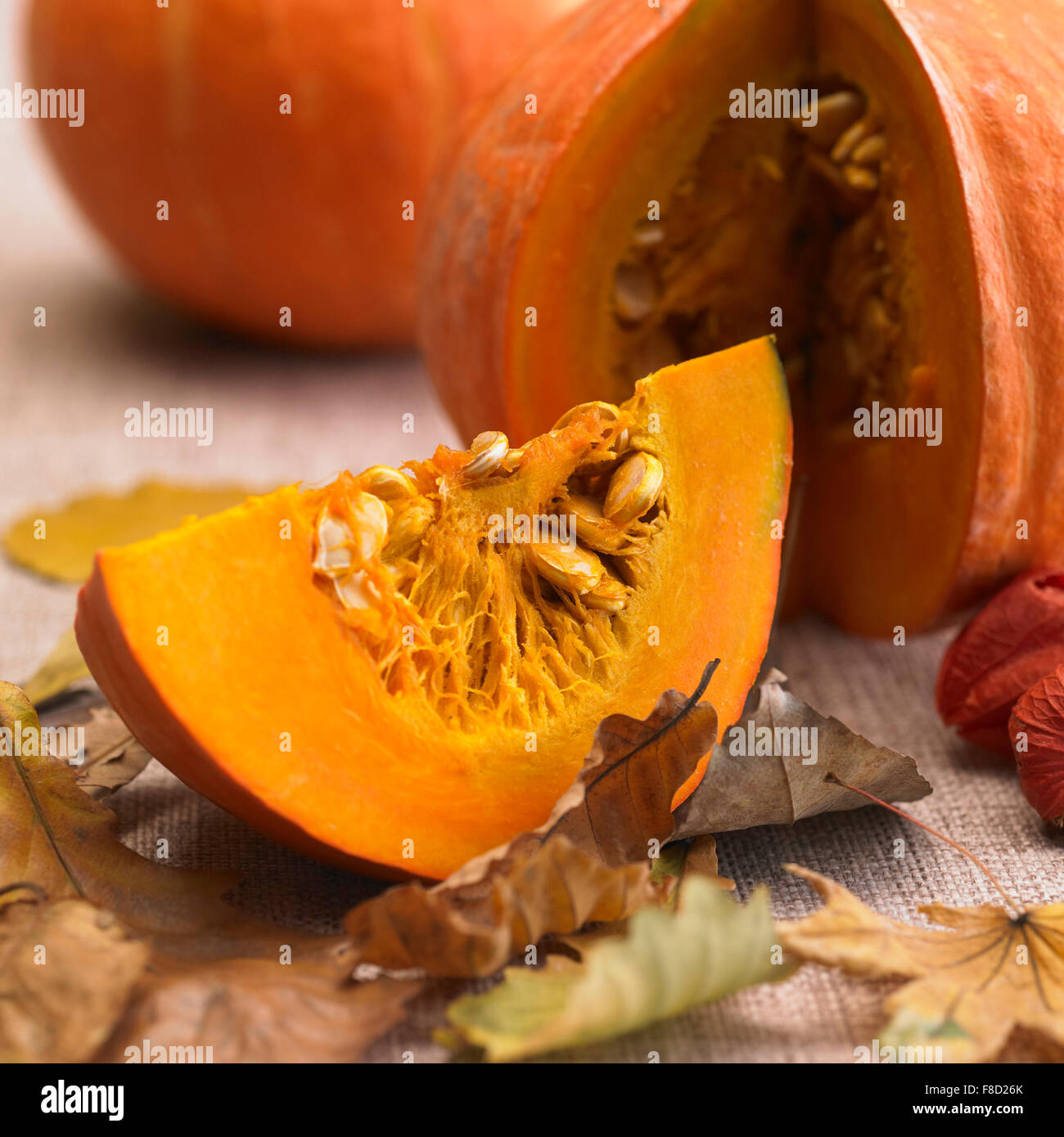 Slice of pumpkin showing its inside with seeds with the decoration of ...