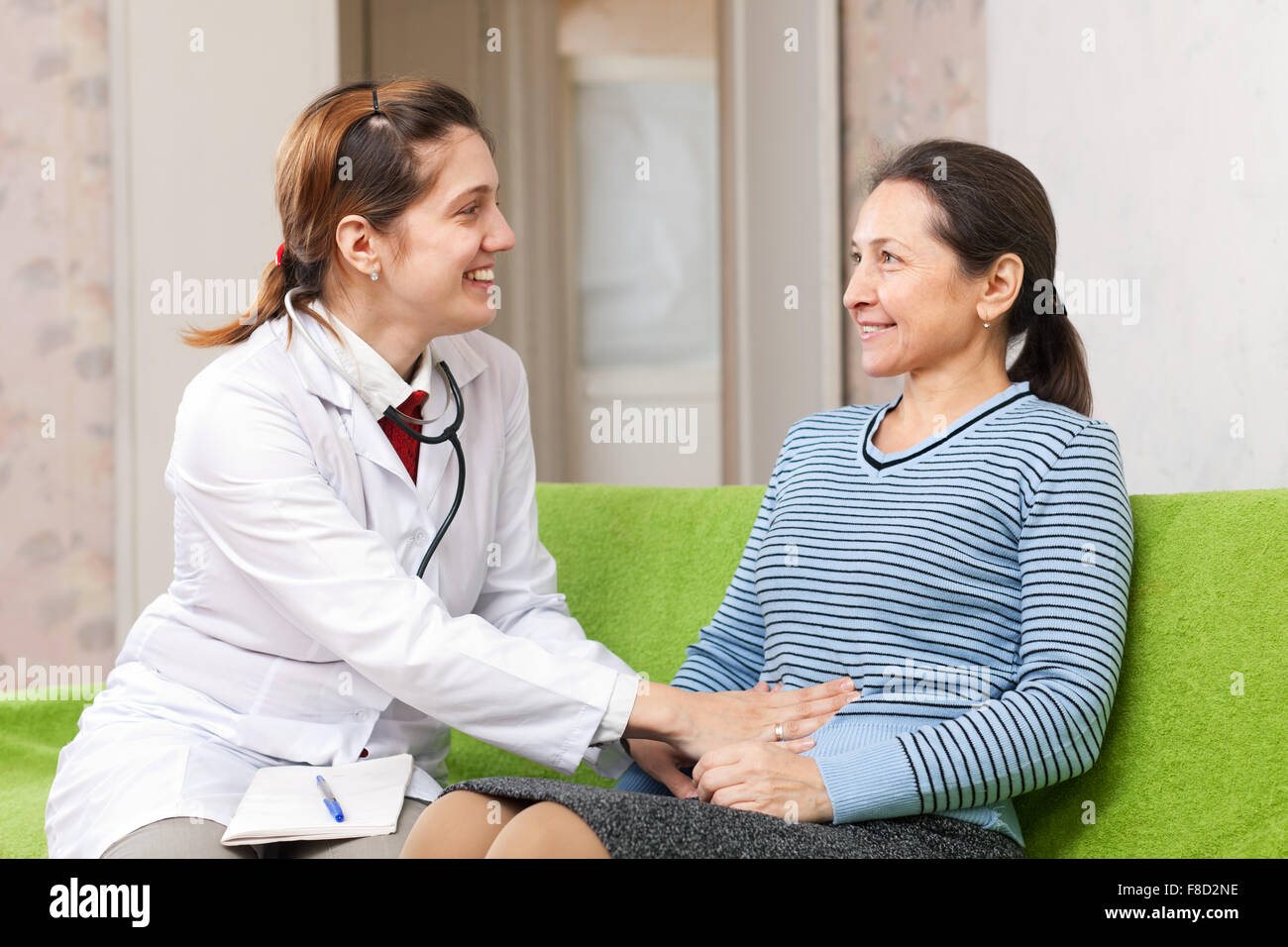 Doctor touching stomach of mature patient in clinic Stock Photo - Alamy