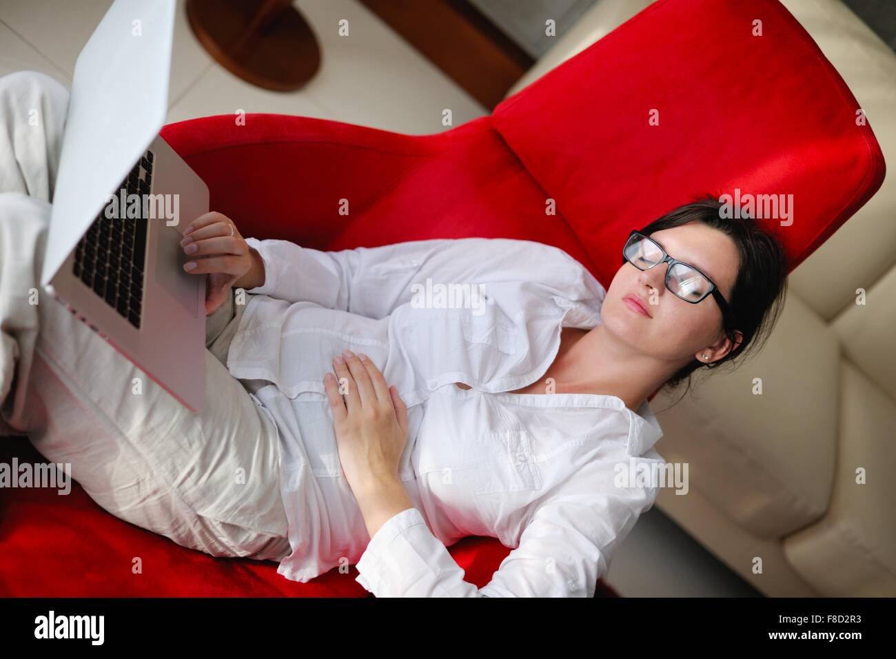 woman working on laptop computer and relax at modern home Stock Photo ...