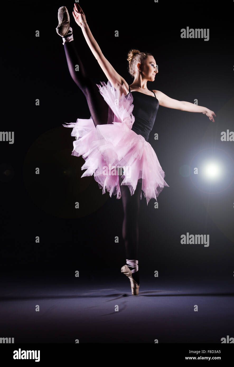 Ballerina dancing in the dark studio Stock Photo - Alamy