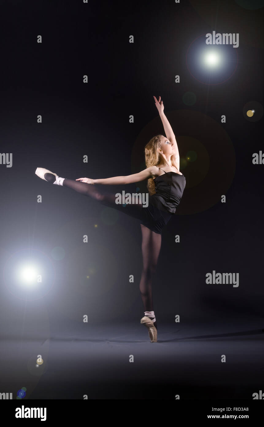 Ballerina dancing in the dark studio Stock Photo - Alamy