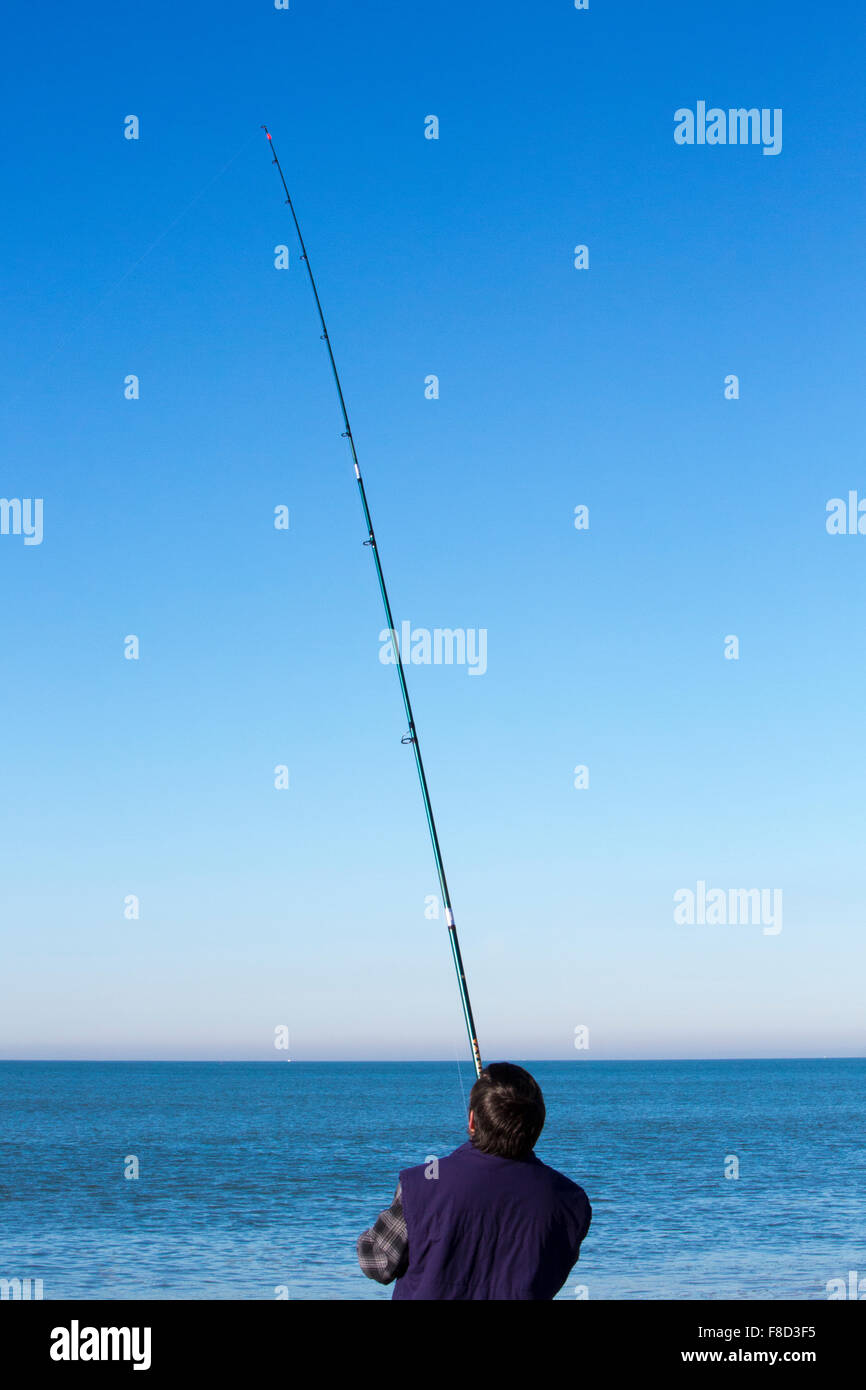Man fishing in ocean on the beach of Biarritz Stock Photo - Alamy
