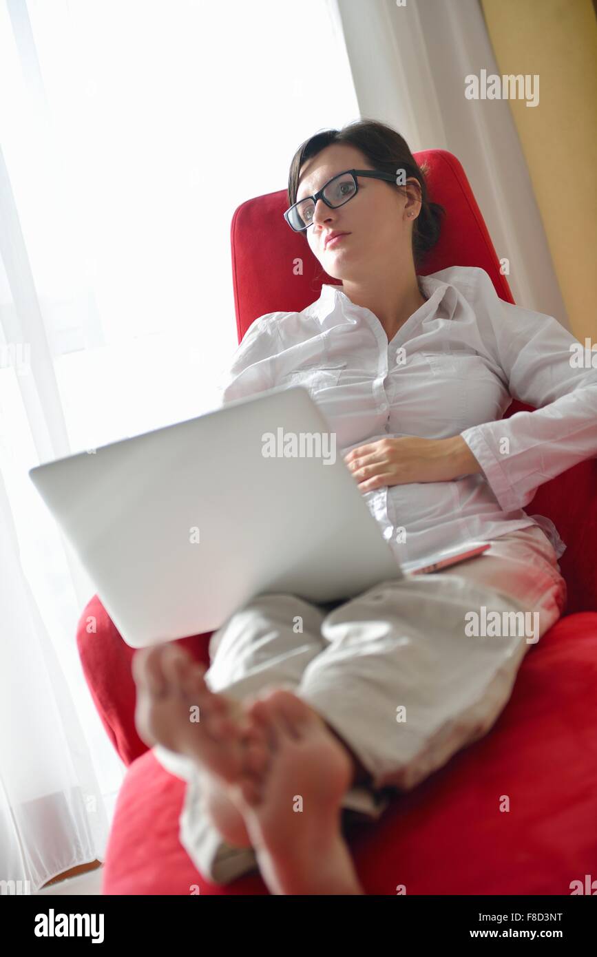 woman working on laptop computer and relax at modern home Stock Photo ...