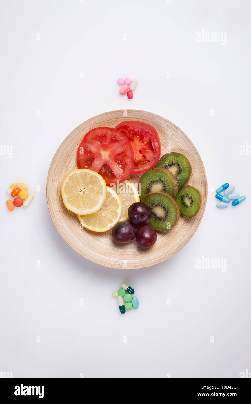 High angle of colorful vitamin pills around a plate with different ...
