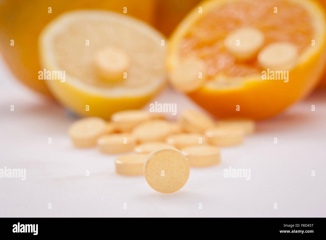 Vitamin pill out of focus with the background of orange and lemon with ...