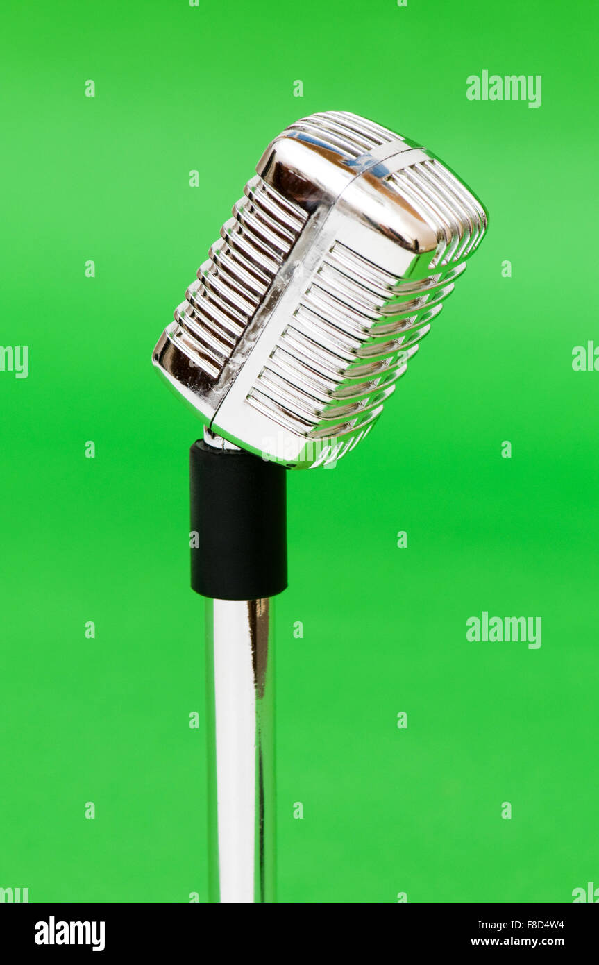 Vintage microphone against the bright green background Stock Photo - Alamy