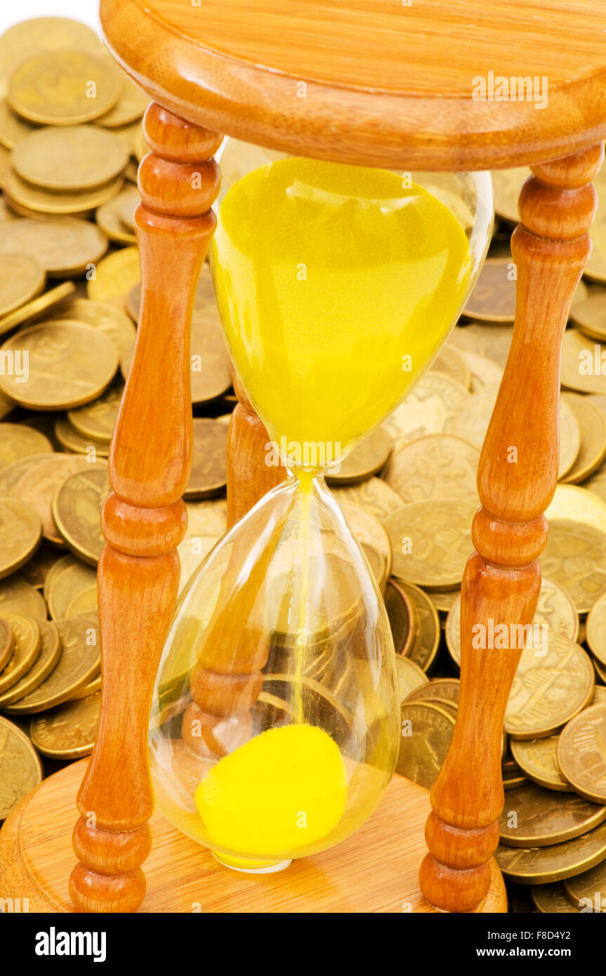 Time is money concept - hourglass and coins Stock Photo - Alamy