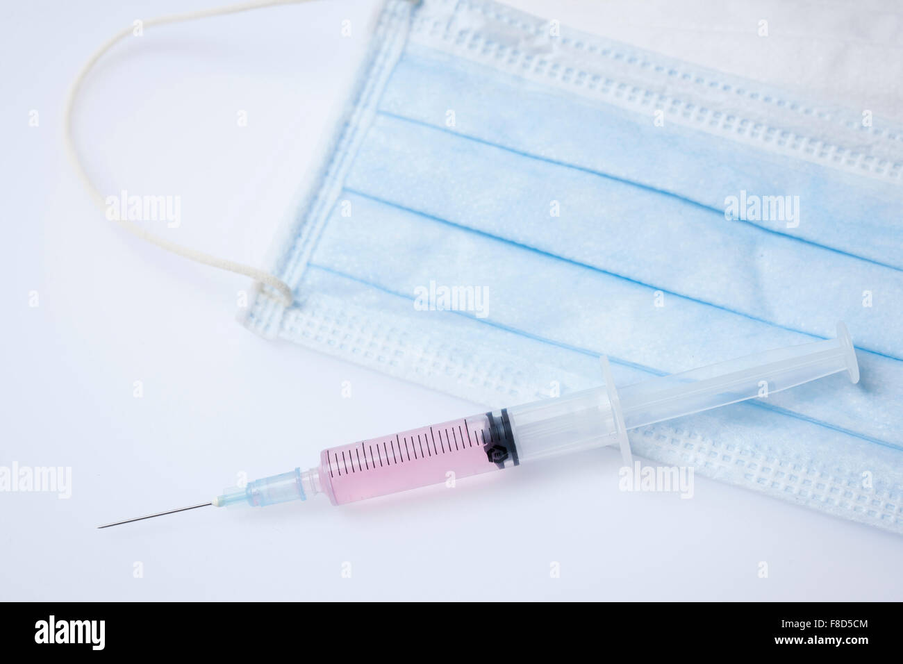 High angle of syringe and a mask Stock Photo - Alamy