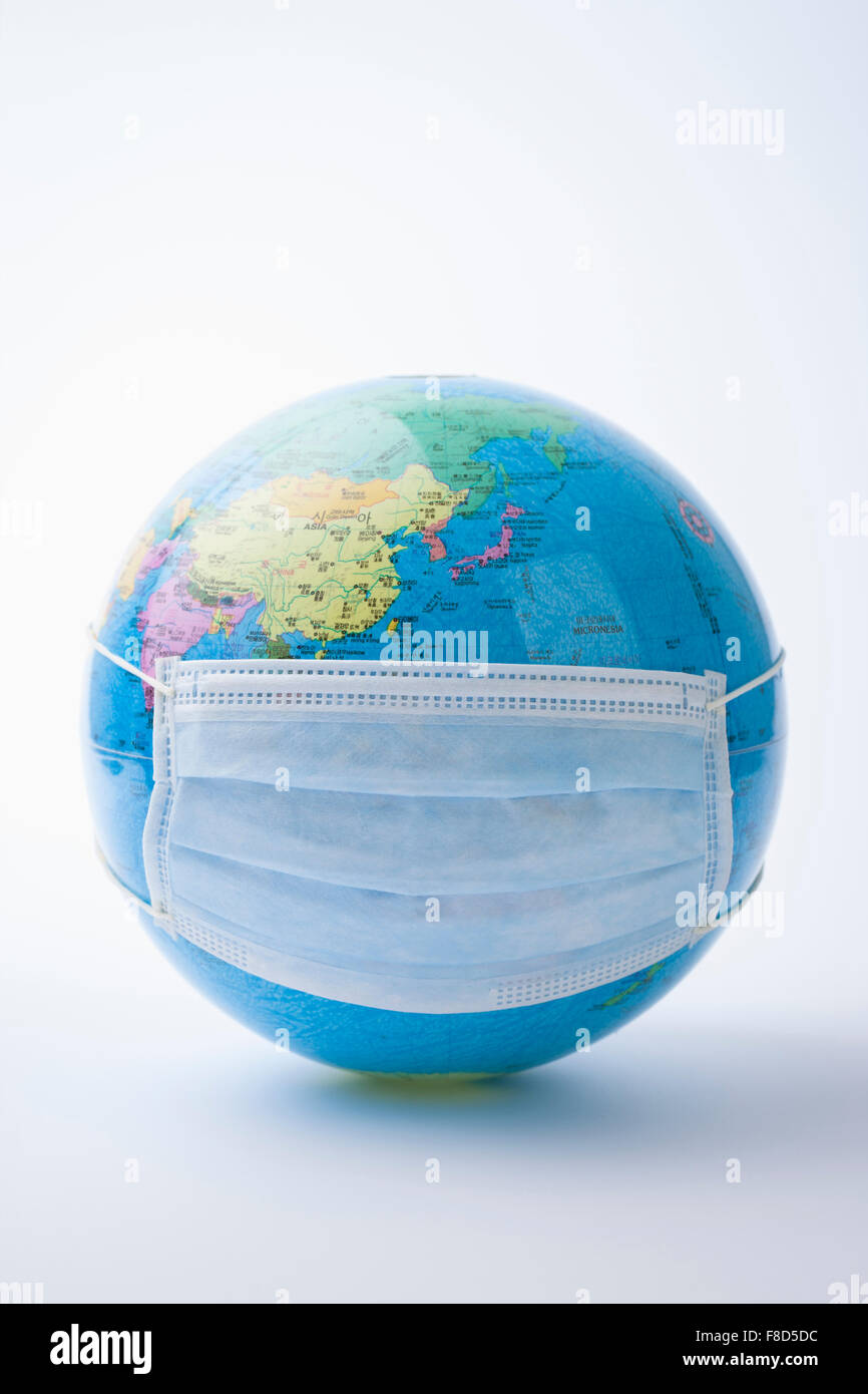 Globe wearing a mask Stock Photo - Alamy