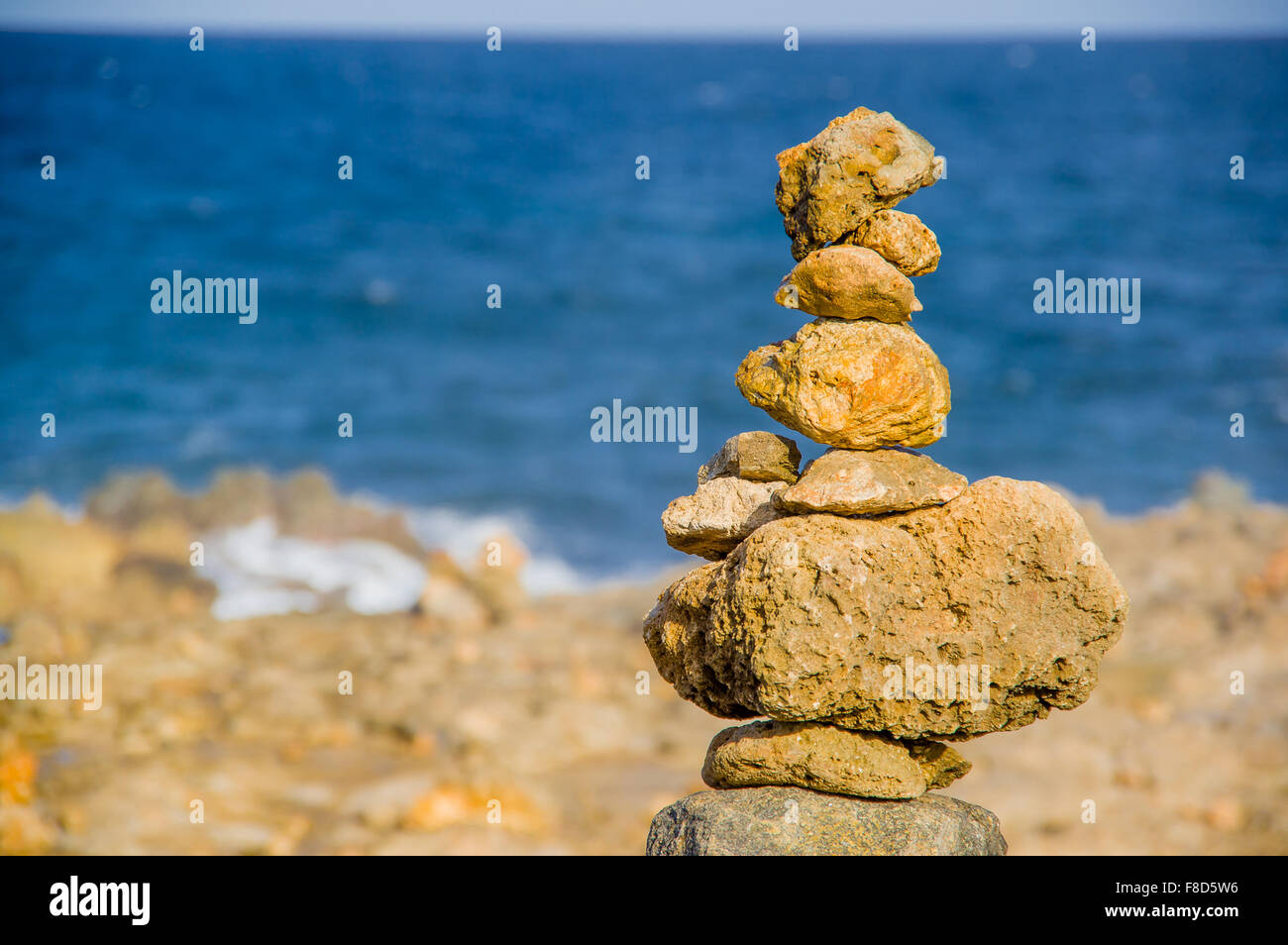 Stack of stones on sea shore, Aruba Stock Photo - Alamy