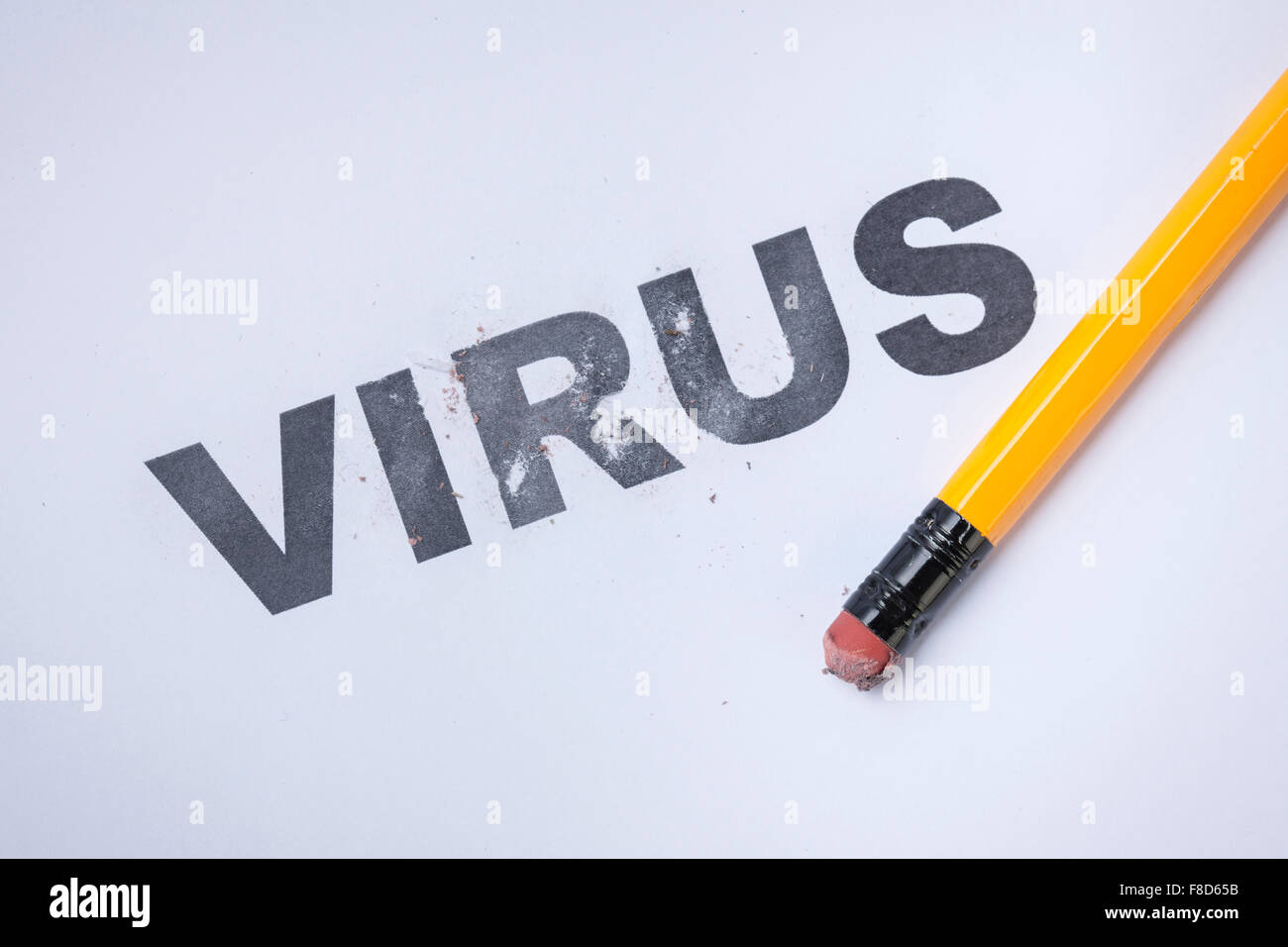 High angle of a word VIRUS written on a white background and a pendcil ...