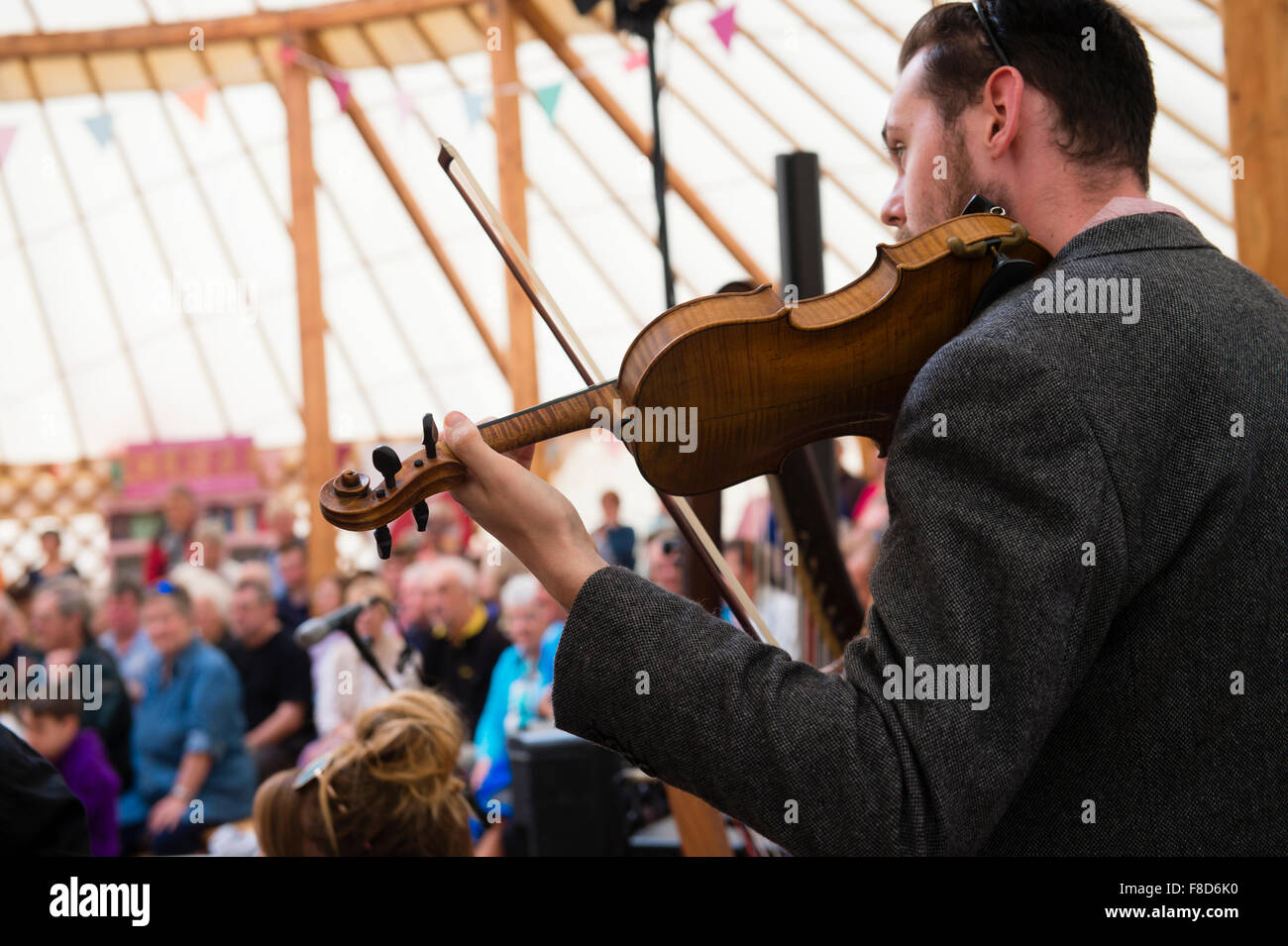 A man playing folk fiddle violin in The National Eisteddfod of Wales ...