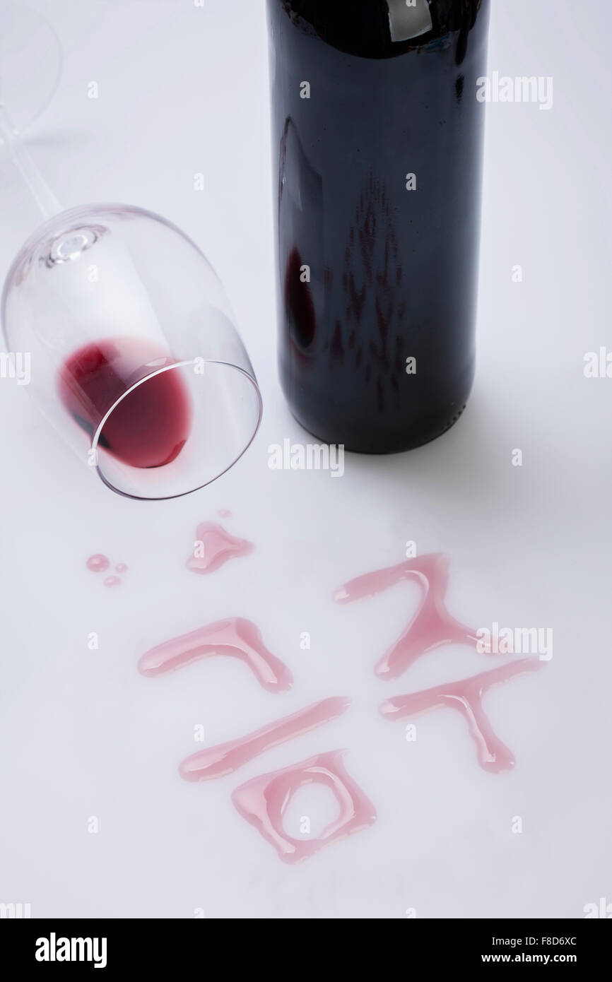 High angle of word meaning "stop drinking" in Korean written with red ...