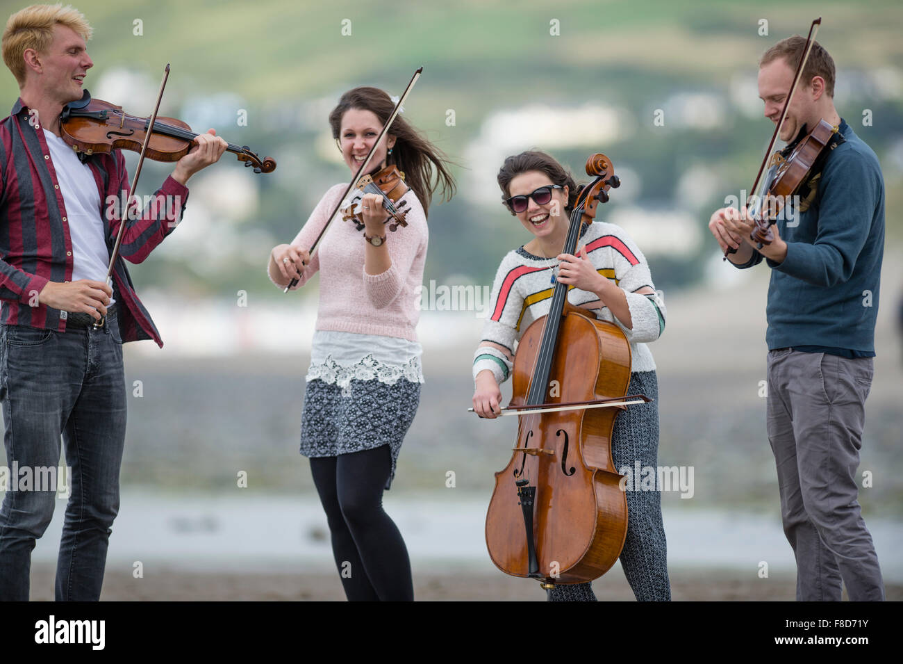Young classical musicians: The Solem String Quartet playing outdoors on ...