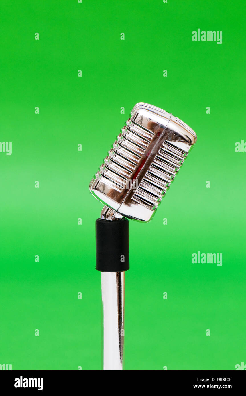 Vintage microphone against the bright green background Stock Photo - Alamy