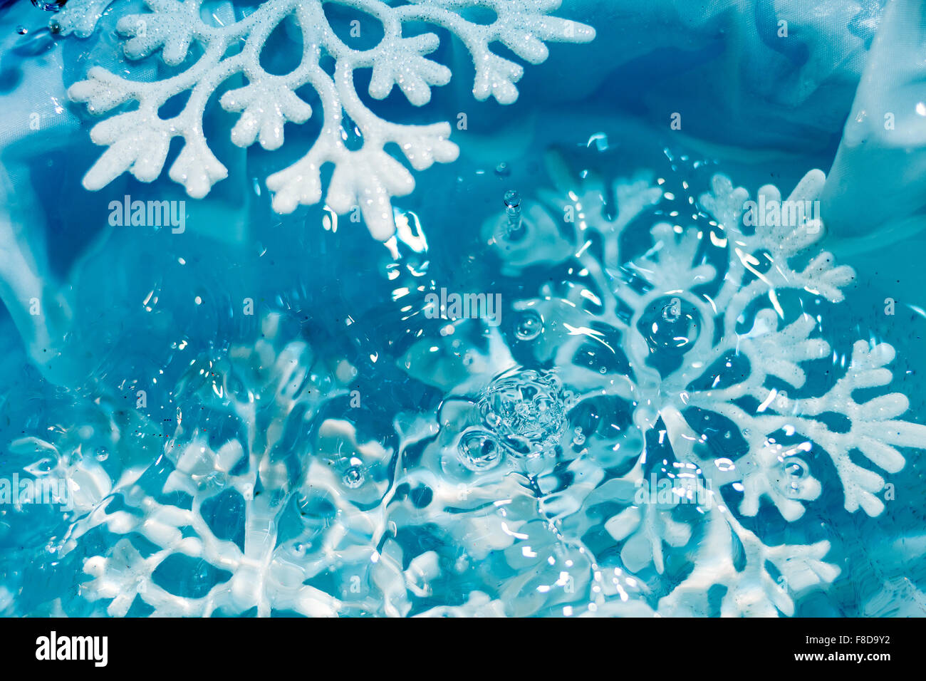 snowflake melts in ice water drops macro cool blue background Stock ...
