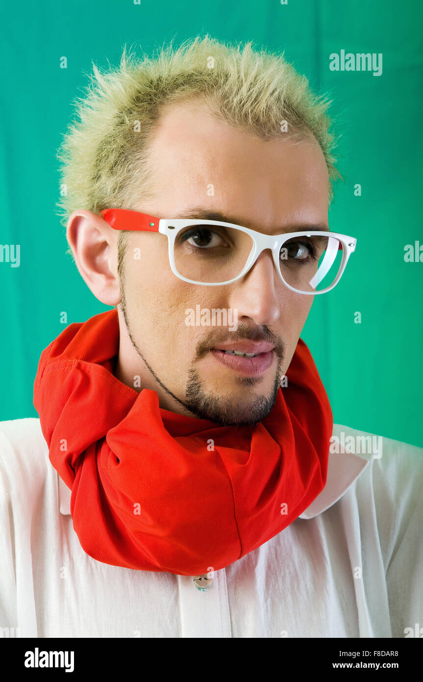Man with red scarf against coloured background Stock Photo - Alamy