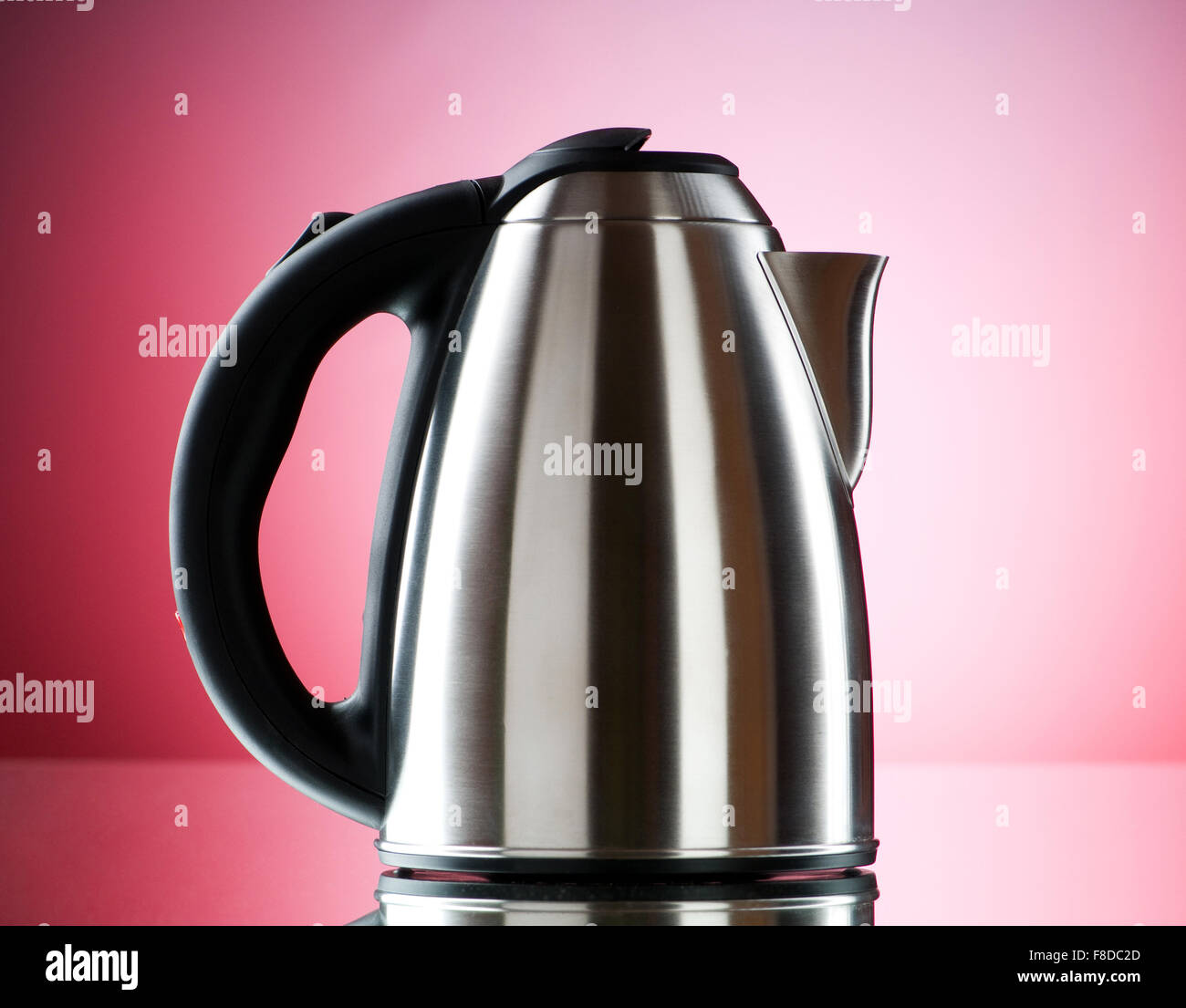 Shiny kettle against the colorful gradient background Stock Photo - Alamy