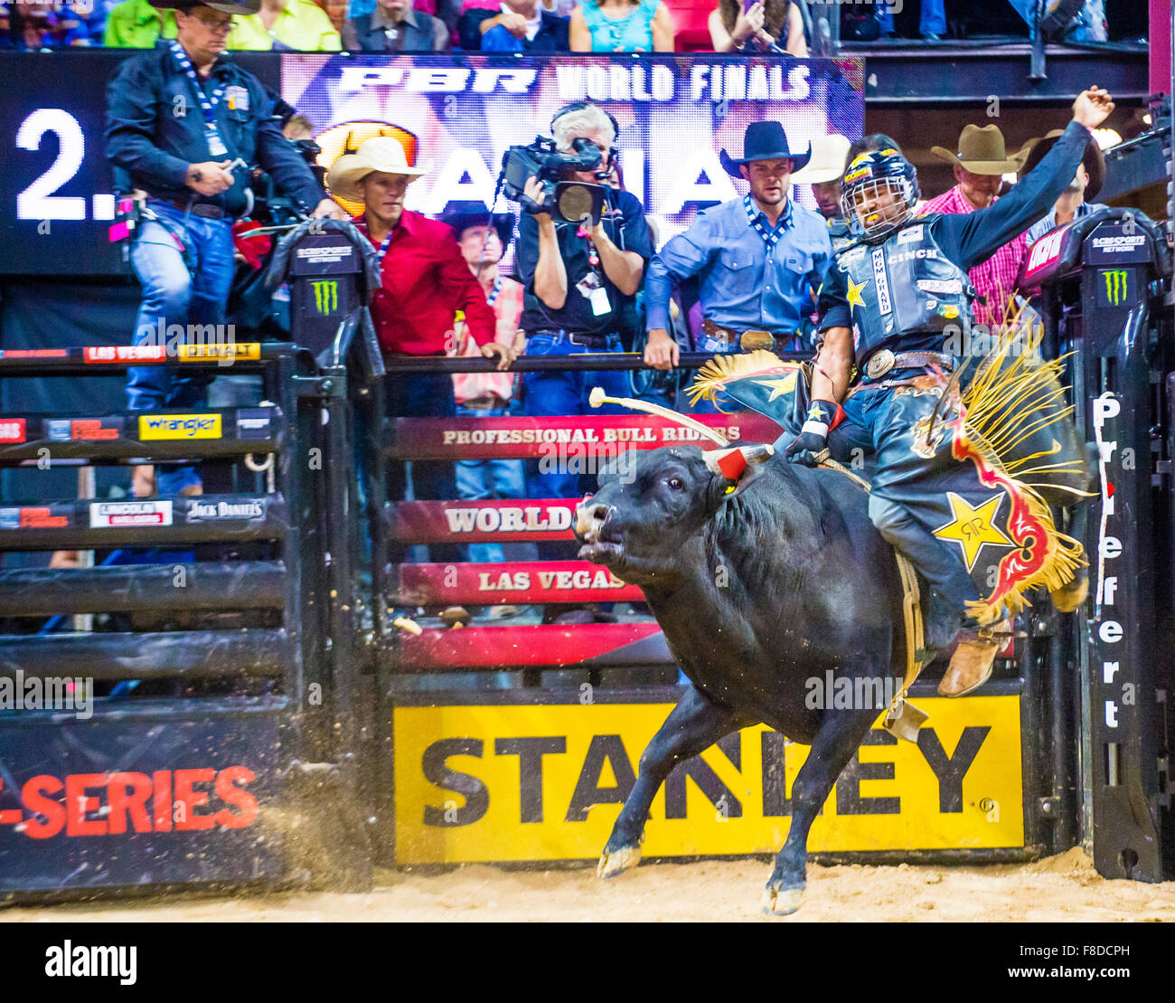 Cowboy Participating in the PBR bull riding world finals. The bull ...