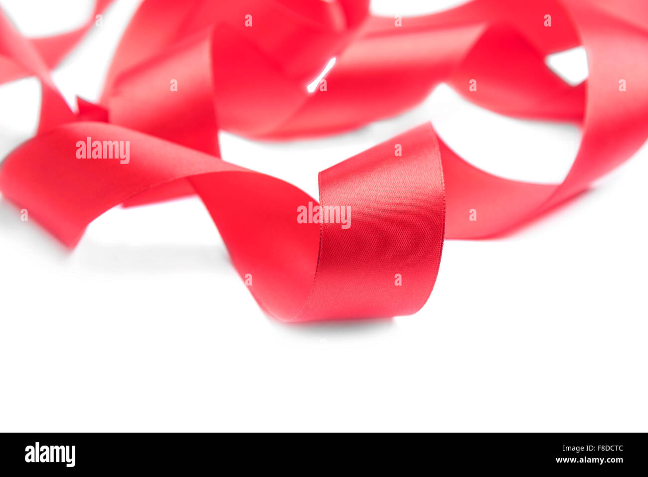 Red ribbon spiral on a white background Stock Photo - Alamy