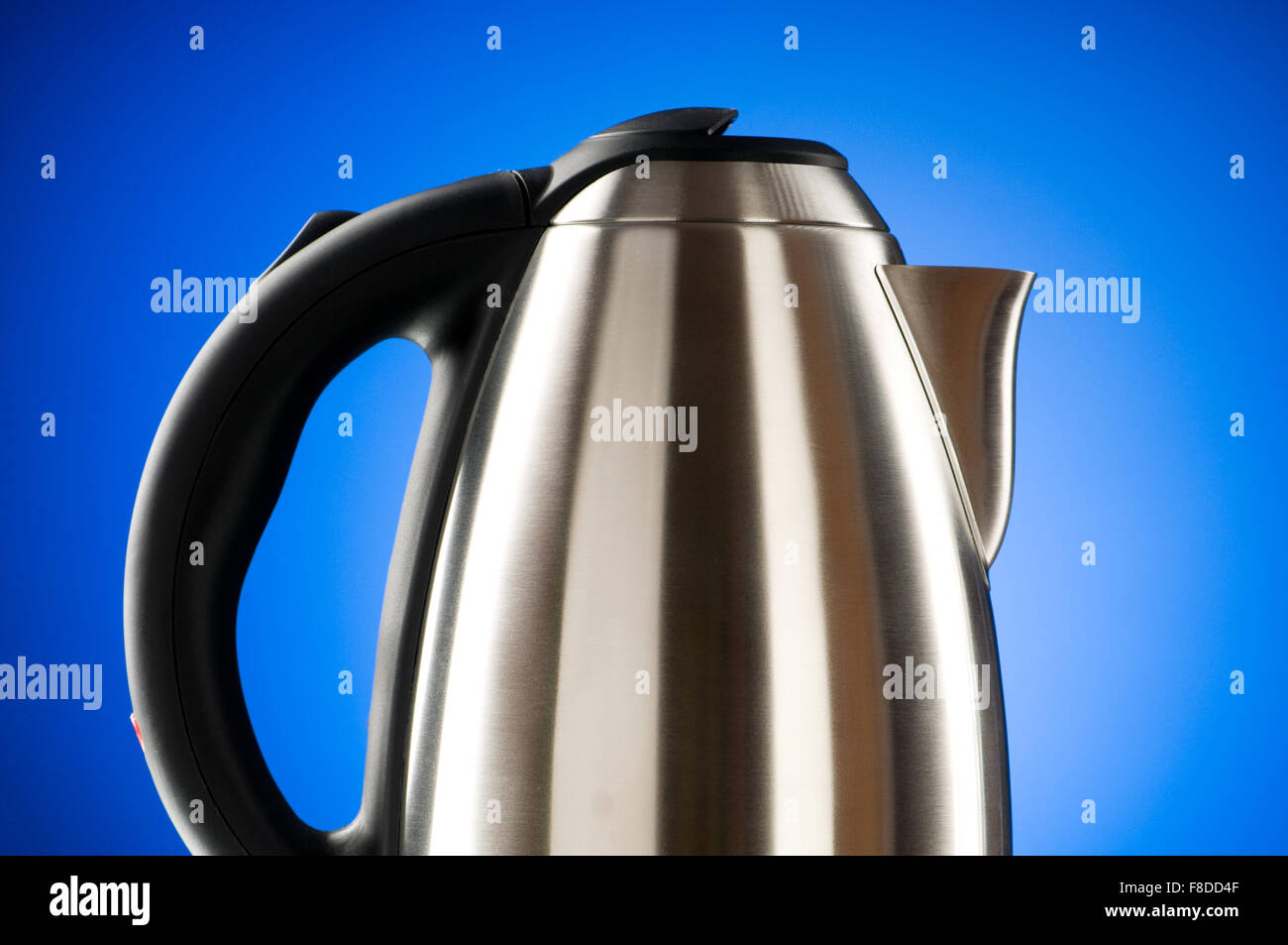 Shiny kettle against the colorful gradient background Stock Photo - Alamy