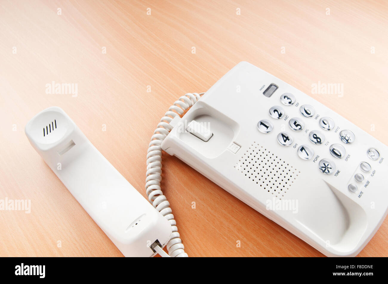 White office phone on the flat surface Stock Photo - Alamy
