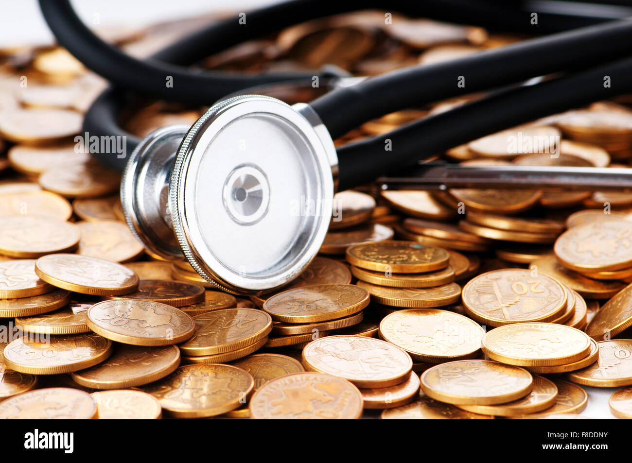 Concept of expensive healthcare with coins and stethoscope Stock Photo ...
