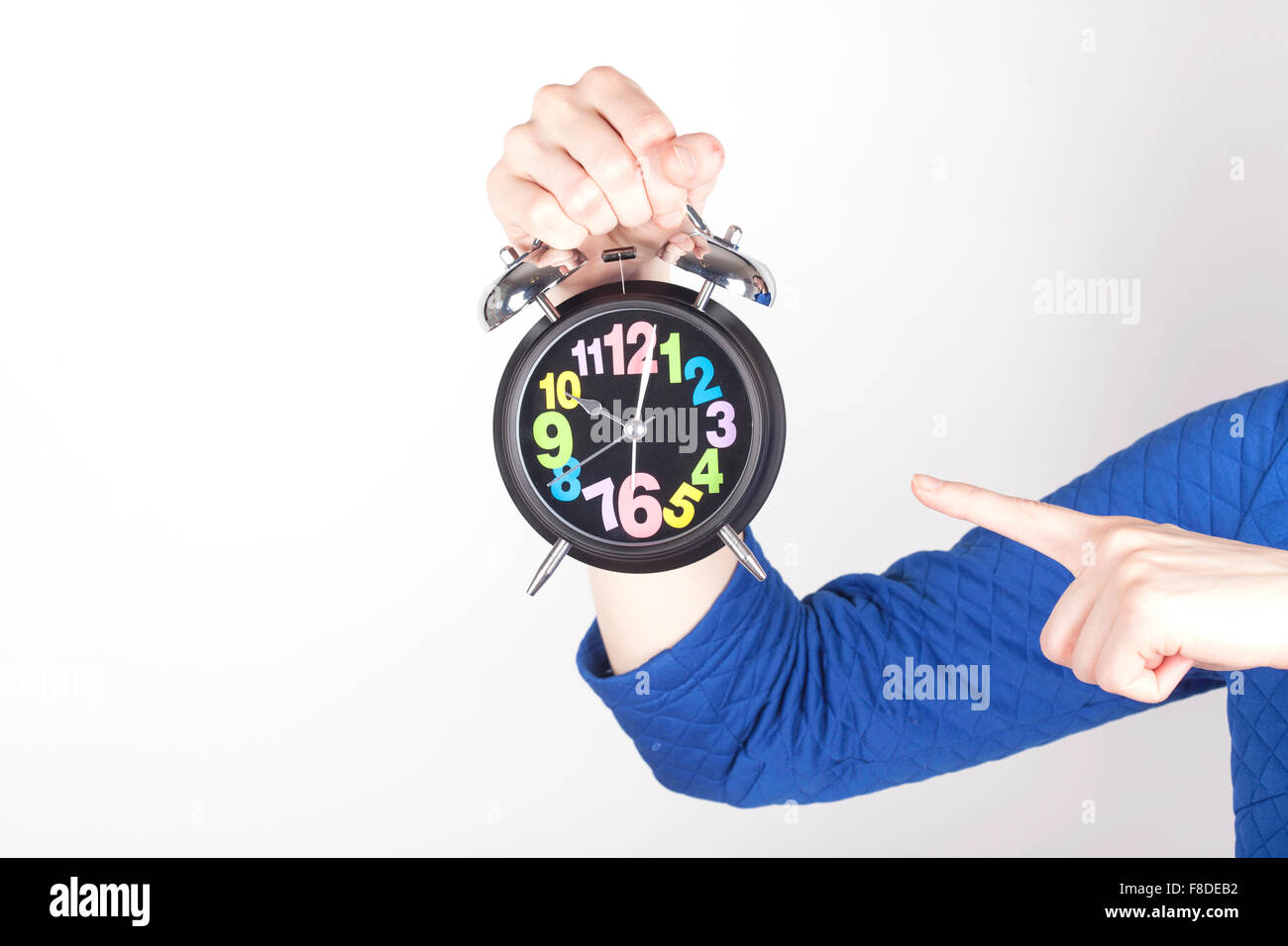 Human index finger pointing at alarm clock, on white background Stock ...