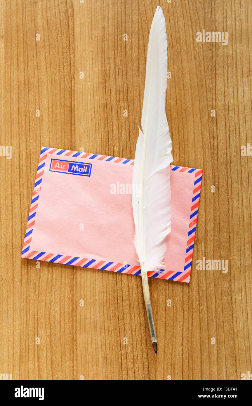 Writing feather and envelope Stock Photo - Alamy