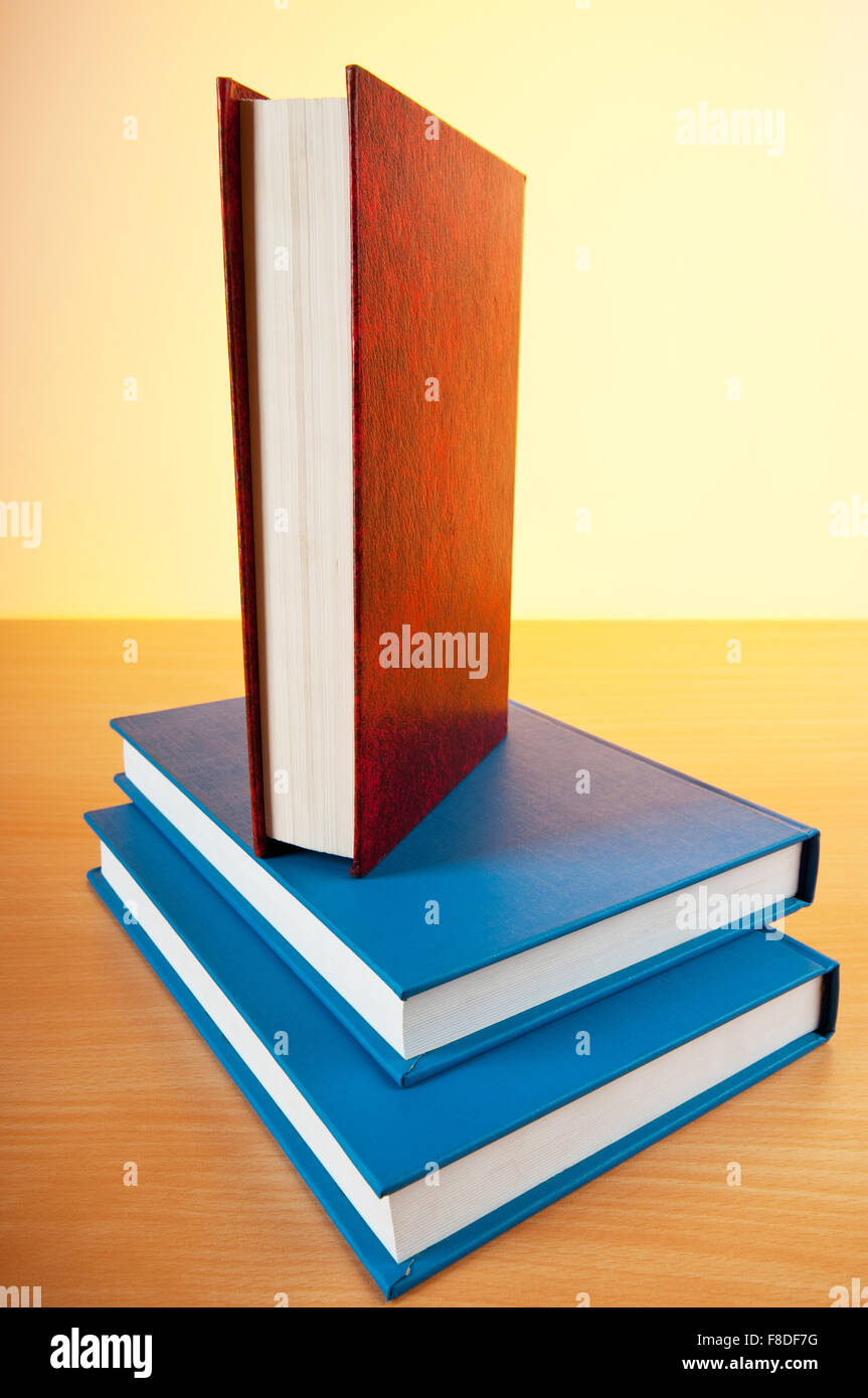 Stack of text books against gradient background Stock Photo - Alamy