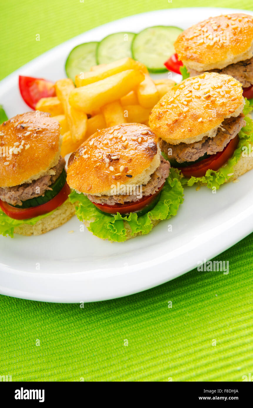 Plate with tasty mini burgers Stock Photo - Alamy