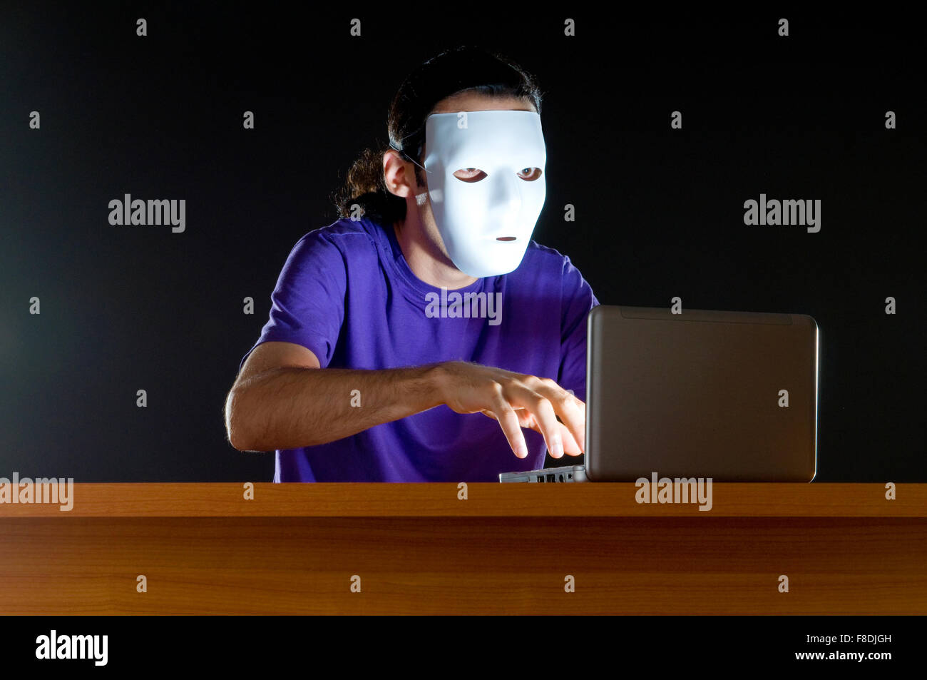 Hacker sitting in dark room Stock Photo - Alamy
