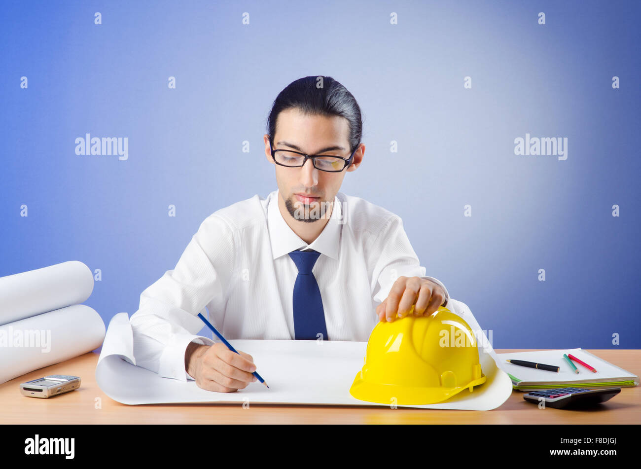 Young engineer looking at drawings Stock Photo - Alamy