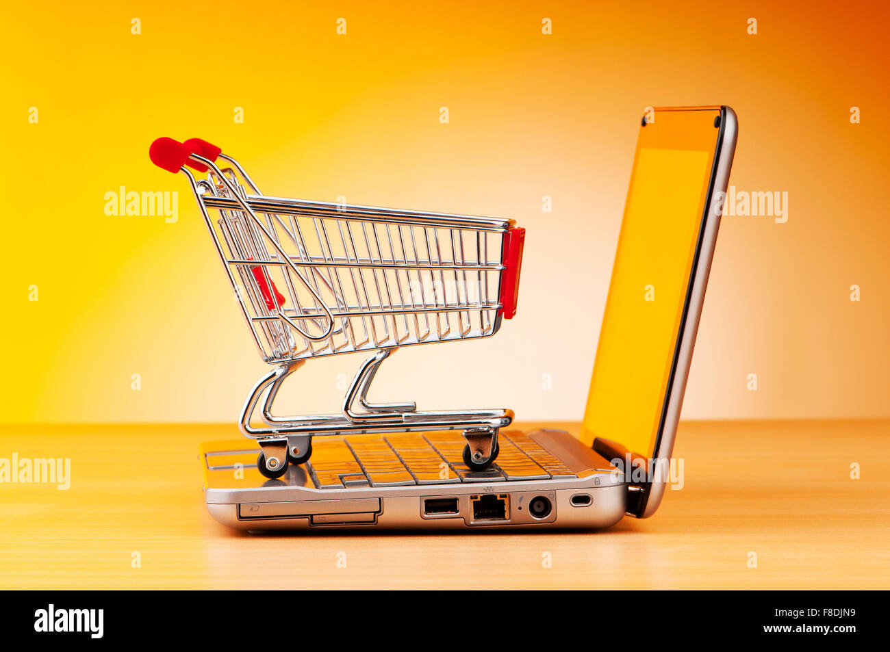 Internet online shopping concept with computer and cart Stock Photo - Alamy