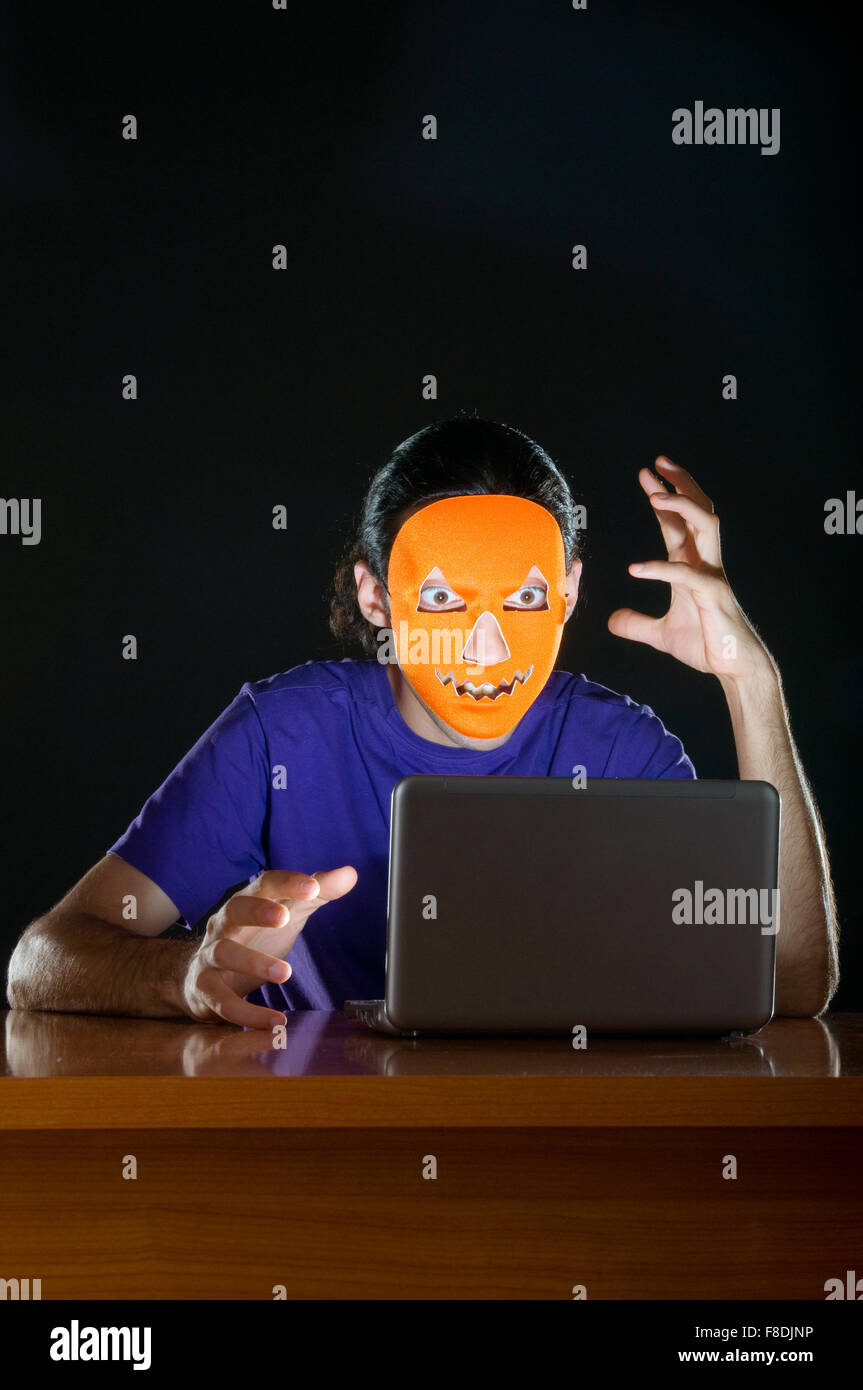 Hacker sitting in dark room Stock Photo - Alamy