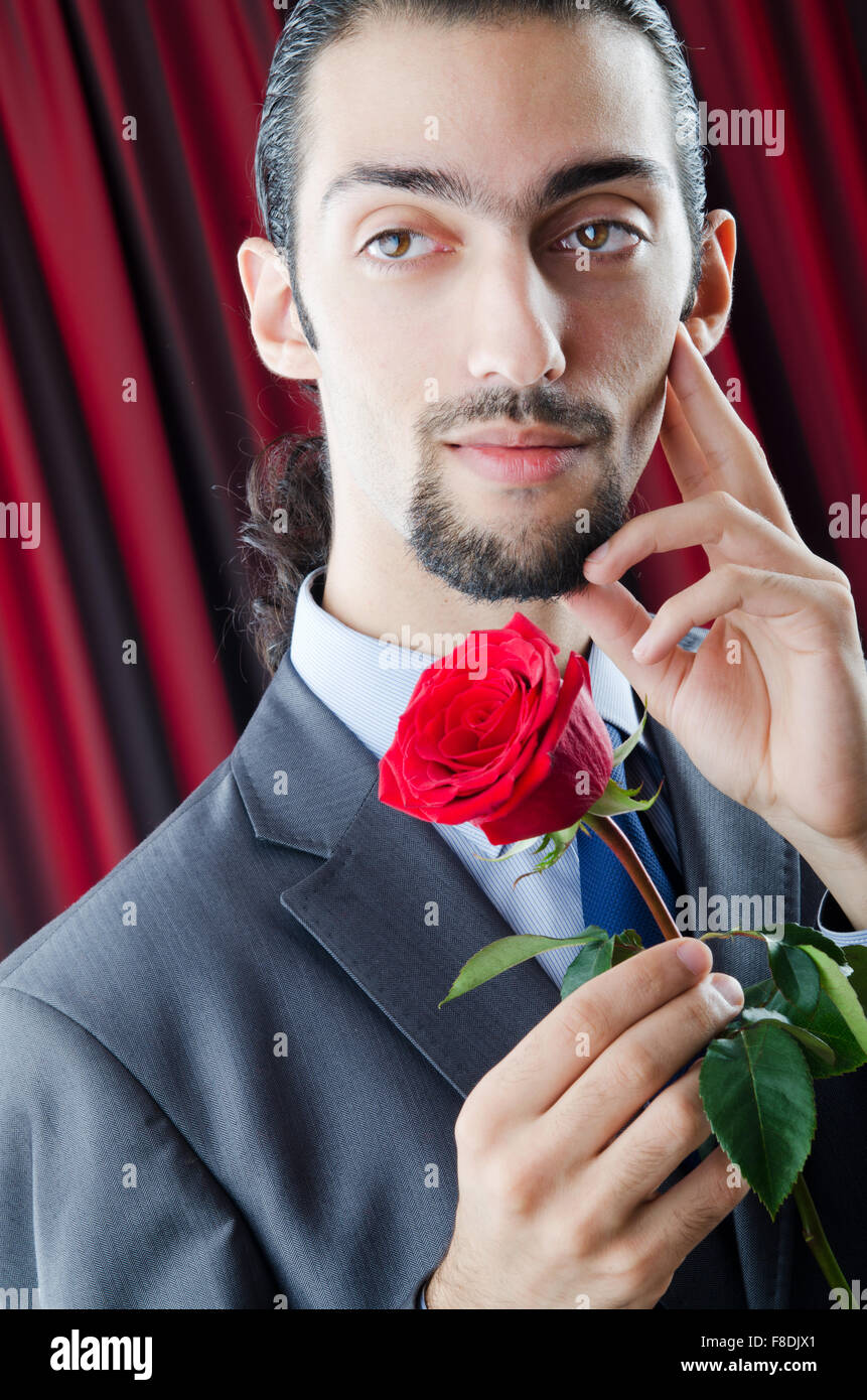 Young man with red rose Stock Photo - Alamy