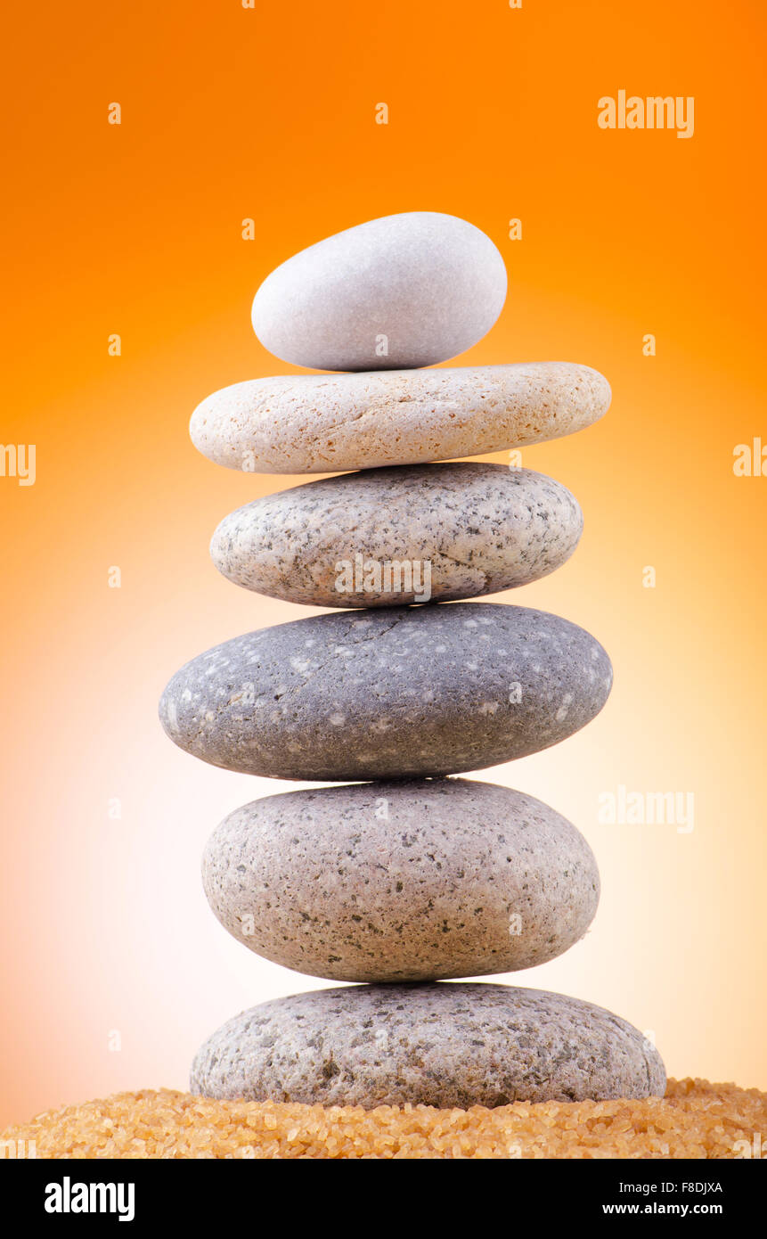 Balanced pebbles with colour background Stock Photo - Alamy