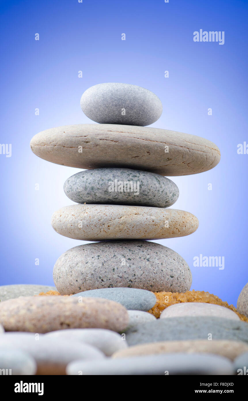 Balanced pebbles with colour background Stock Photo - Alamy