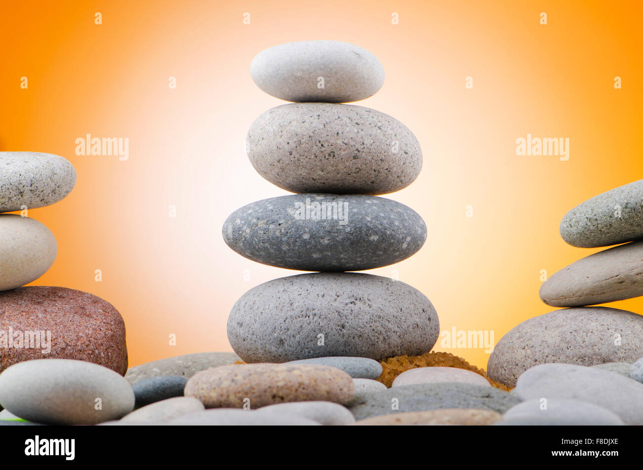 Balanced pebbles with colour background Stock Photo - Alamy